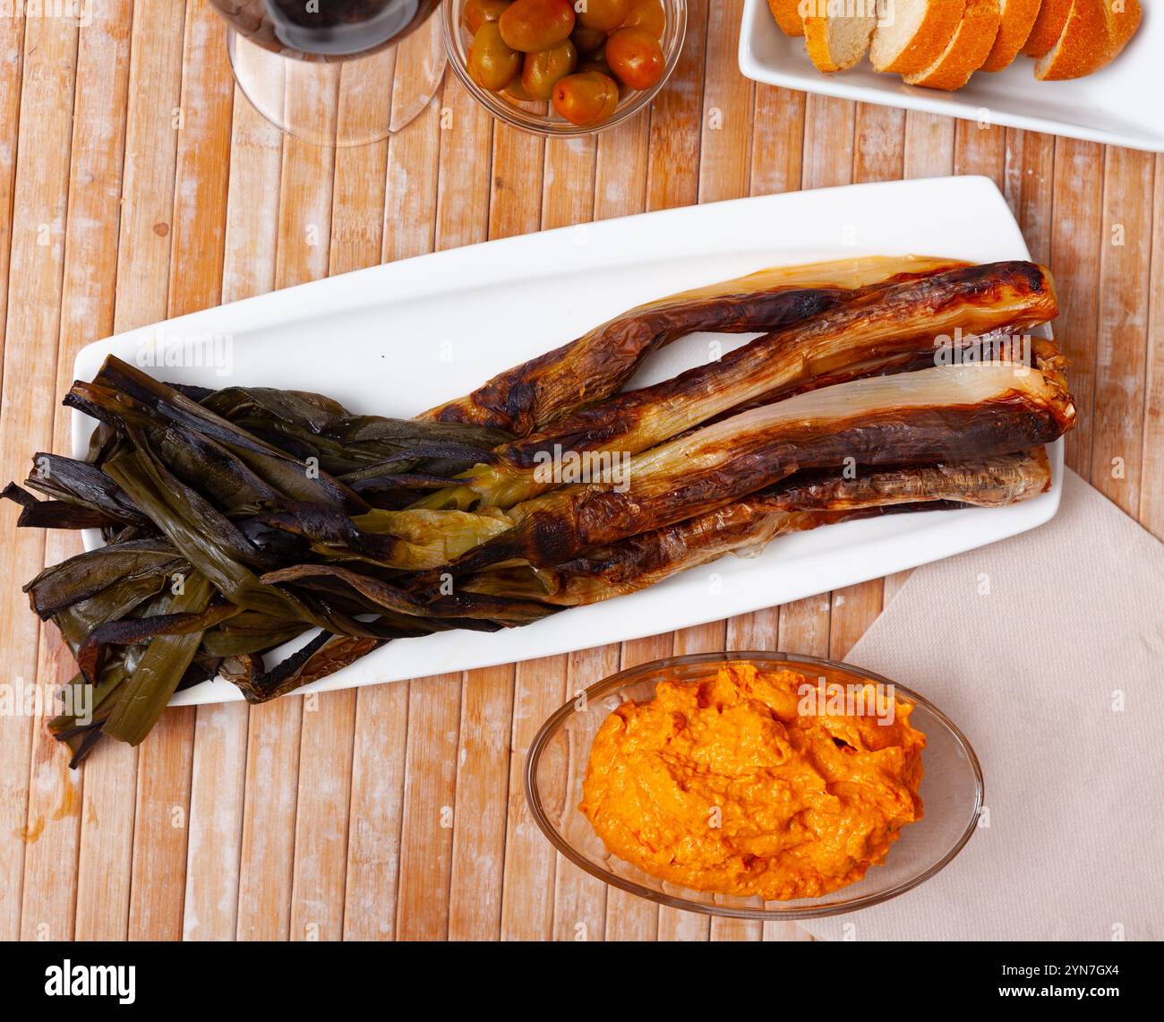 A traditional catalan dish of charred calcot onion and romesco sauce ...