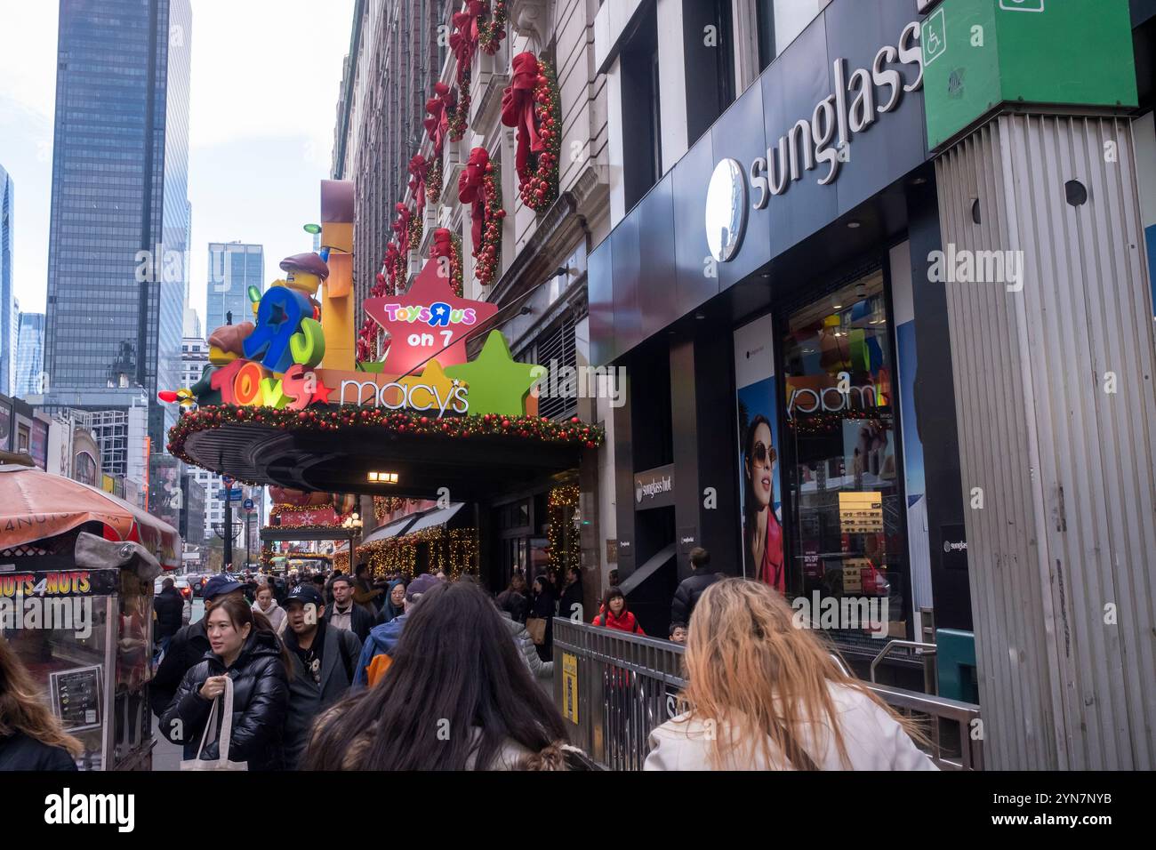NEW YORK, NEW YORK - NOVEMBER 24: People walk by the Macy's holiday ...