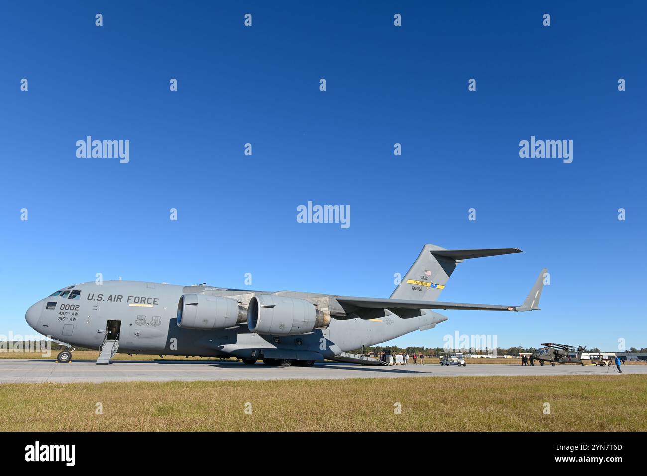 A Boeing AH-64 Apache helicopter is loaded into a U.S. Air Force C-17 ...