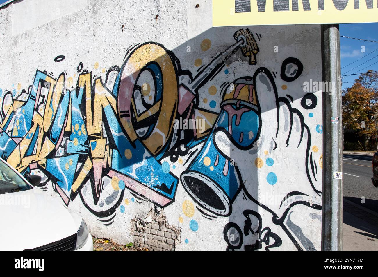 Graffiti artist painting mural on Kingston Road in Scarborough, Toronto ...