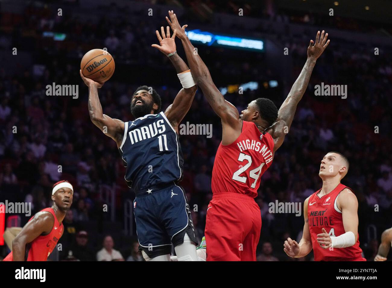 Dallas Mavericks guard Kyrie Irving (11) looks to shoot over Miami Heat ...