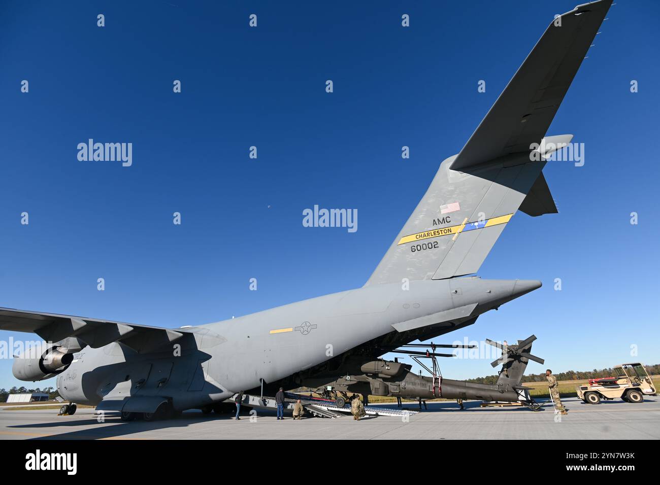 A Boeing AH-64 Apache helicopter is loaded into a U.S. Air Force C-17 ...