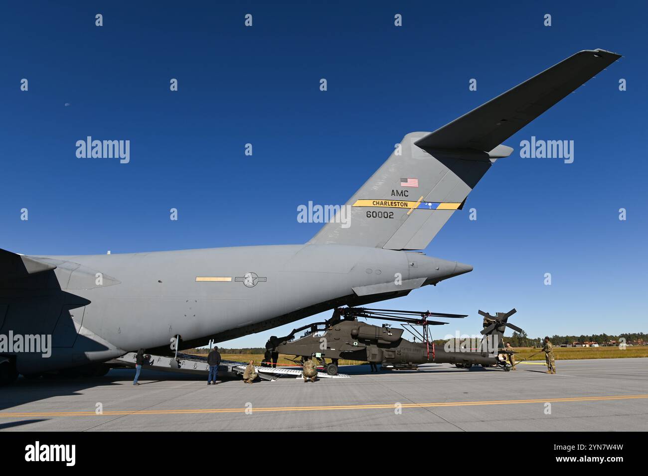 A Boeing AH-64 Apache helicopter is loaded into a U.S. Air Force C-17 ...