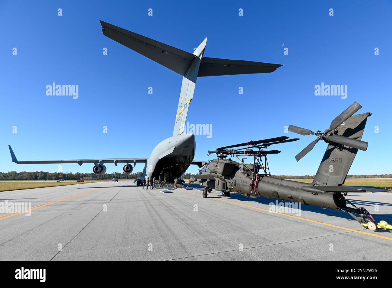 A Boeing AH-64 Apache helicopter is loaded into a U.S. Air Force C-17 ...
