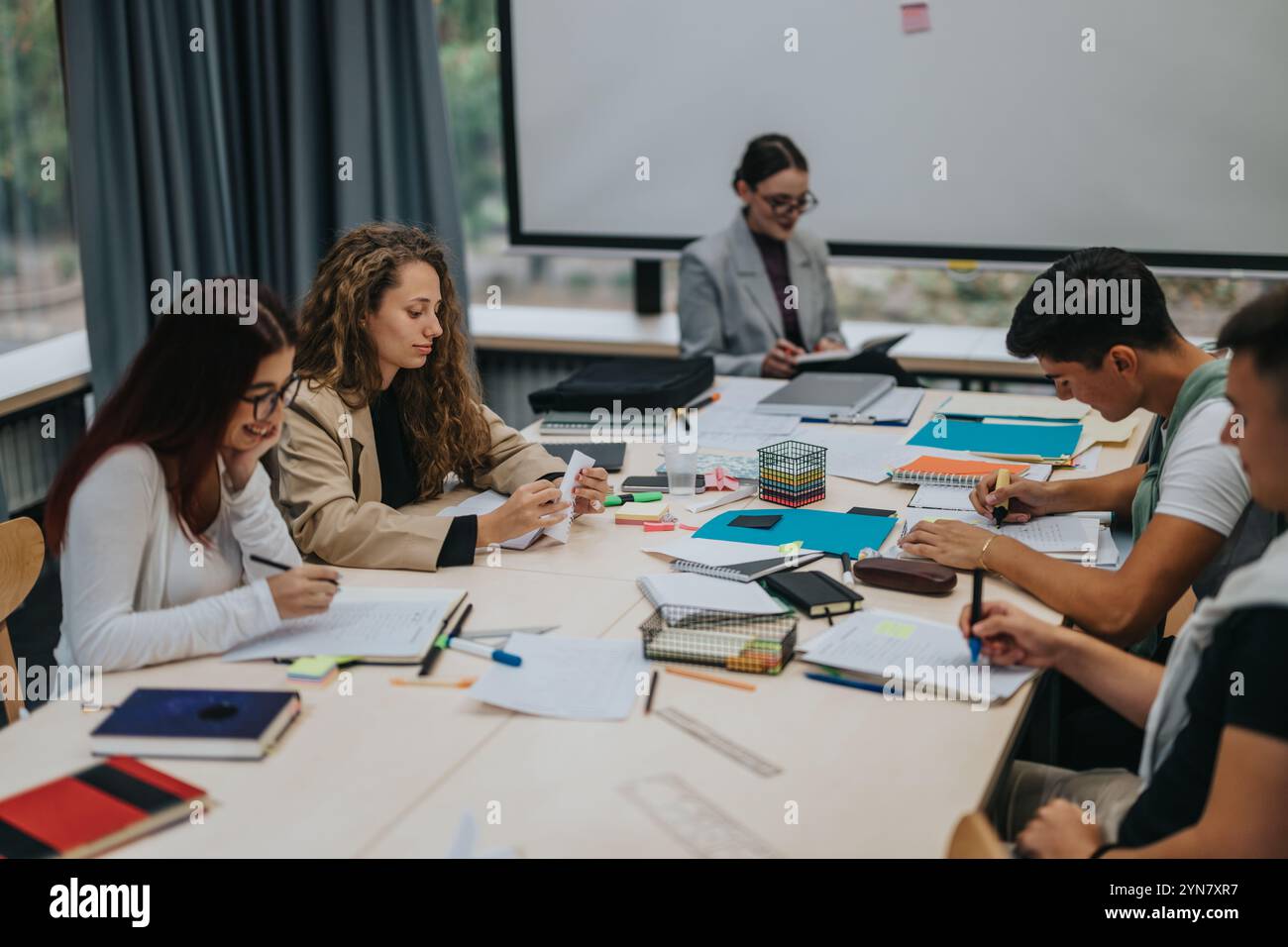 Students collaborating on a group project in a modern classroom Stock ...