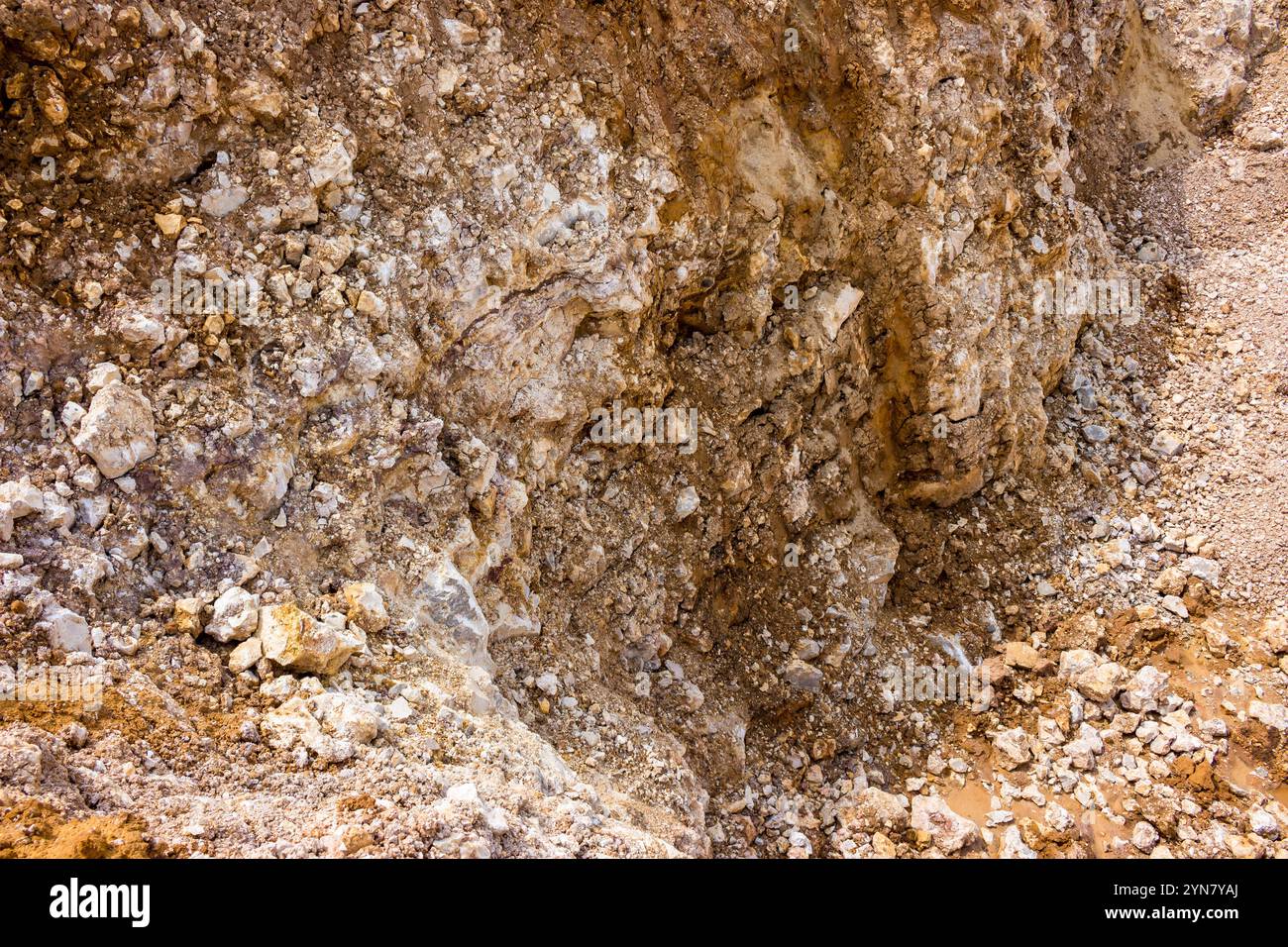 Crumbling wall with rocks in a limestone quarry Stock Photo - Alamy