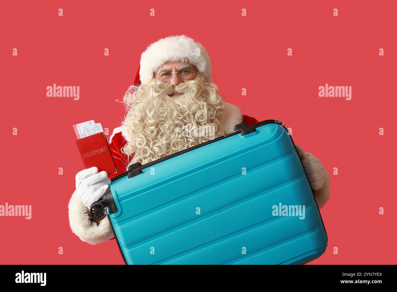 Santa Claus with suitcase, passport and tickets on red background ...