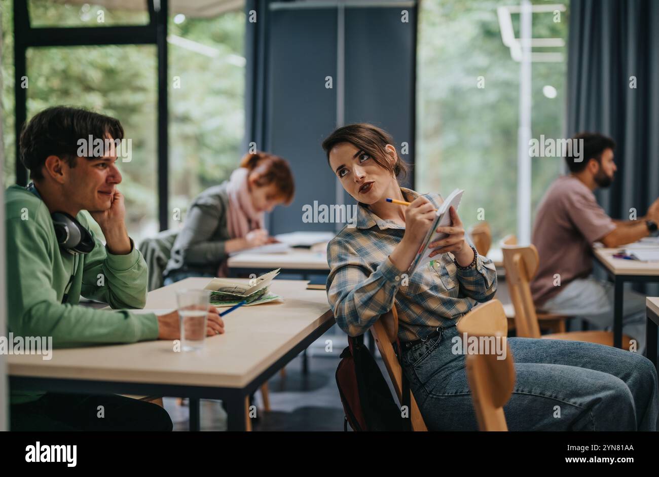 Students attending a cozy classroom session and engaging in discussions ...