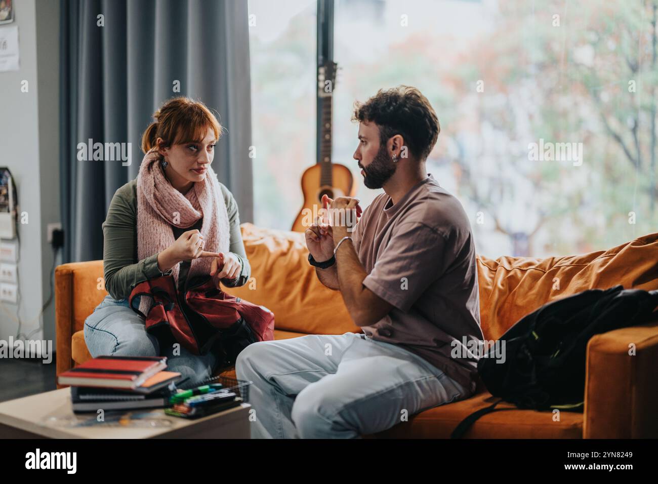 Two students engaged in a thoughtful conversation indoors Stock Photo ...