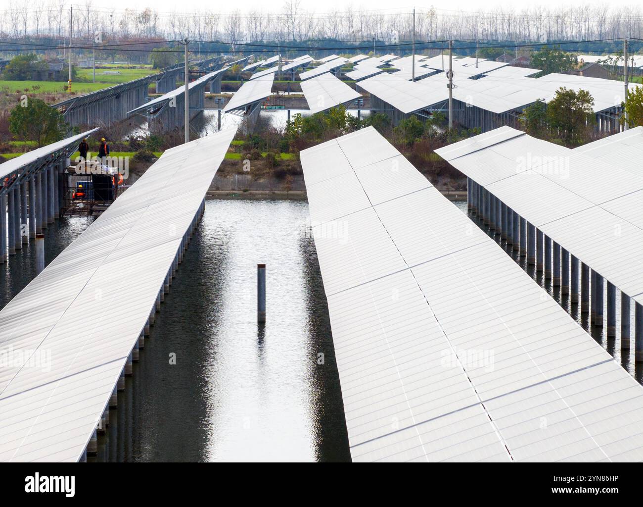 HUAI'AN, CHINA - NOVEMBER 24, 2024 - Workers set up solar panels at the ...