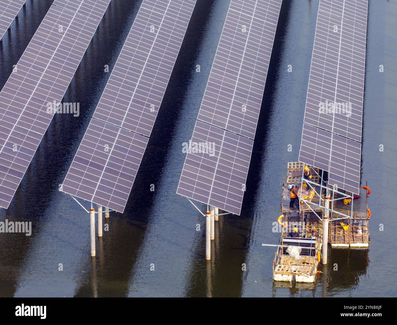 HUAI'AN, CHINA - NOVEMBER 24, 2024 - Workers set up solar panels at the ...