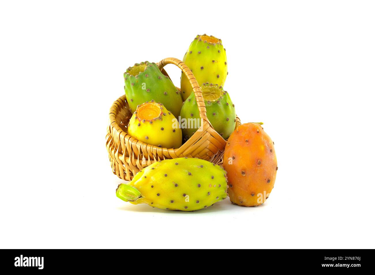Bright prickly pears arranged in a wicker basket against a white ...