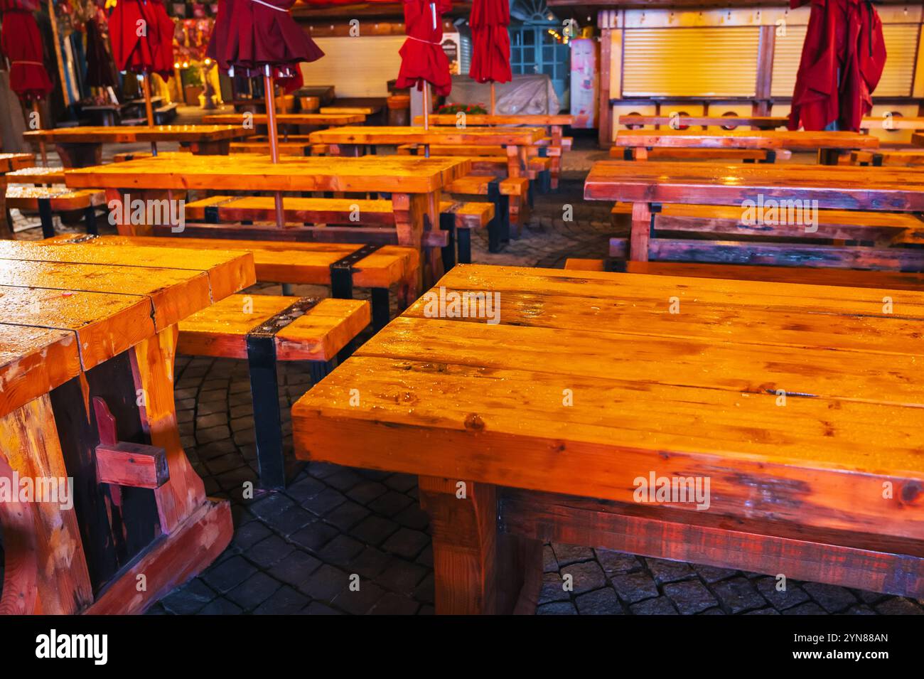 wooden tables and benches in a street cafe in Europe in evening Stock ...