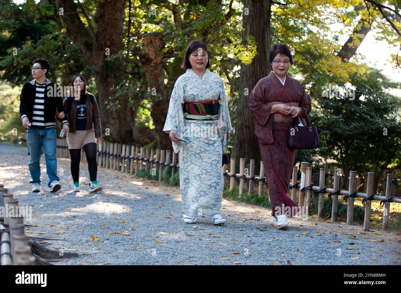 Visitors walking along a stone pathway at the famous Kenrokuen ...