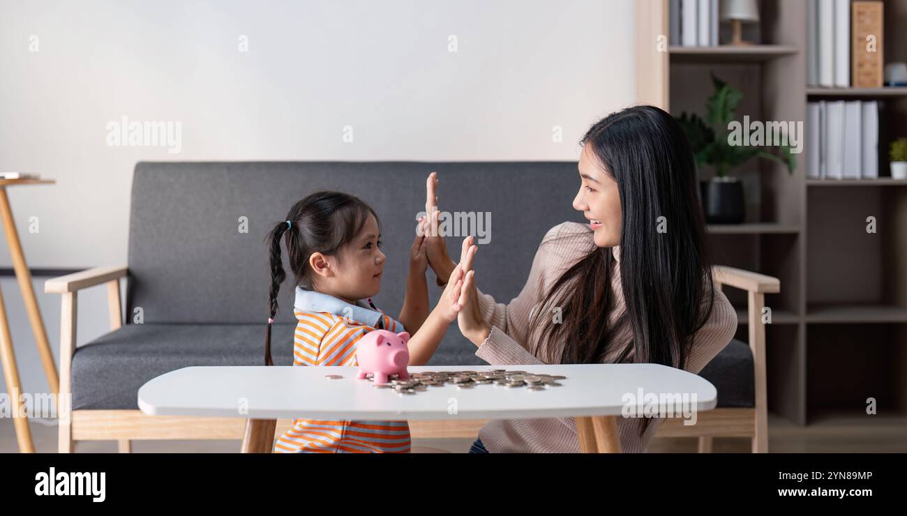 Asian family saving coins hi-res stock photography and images - Alamy