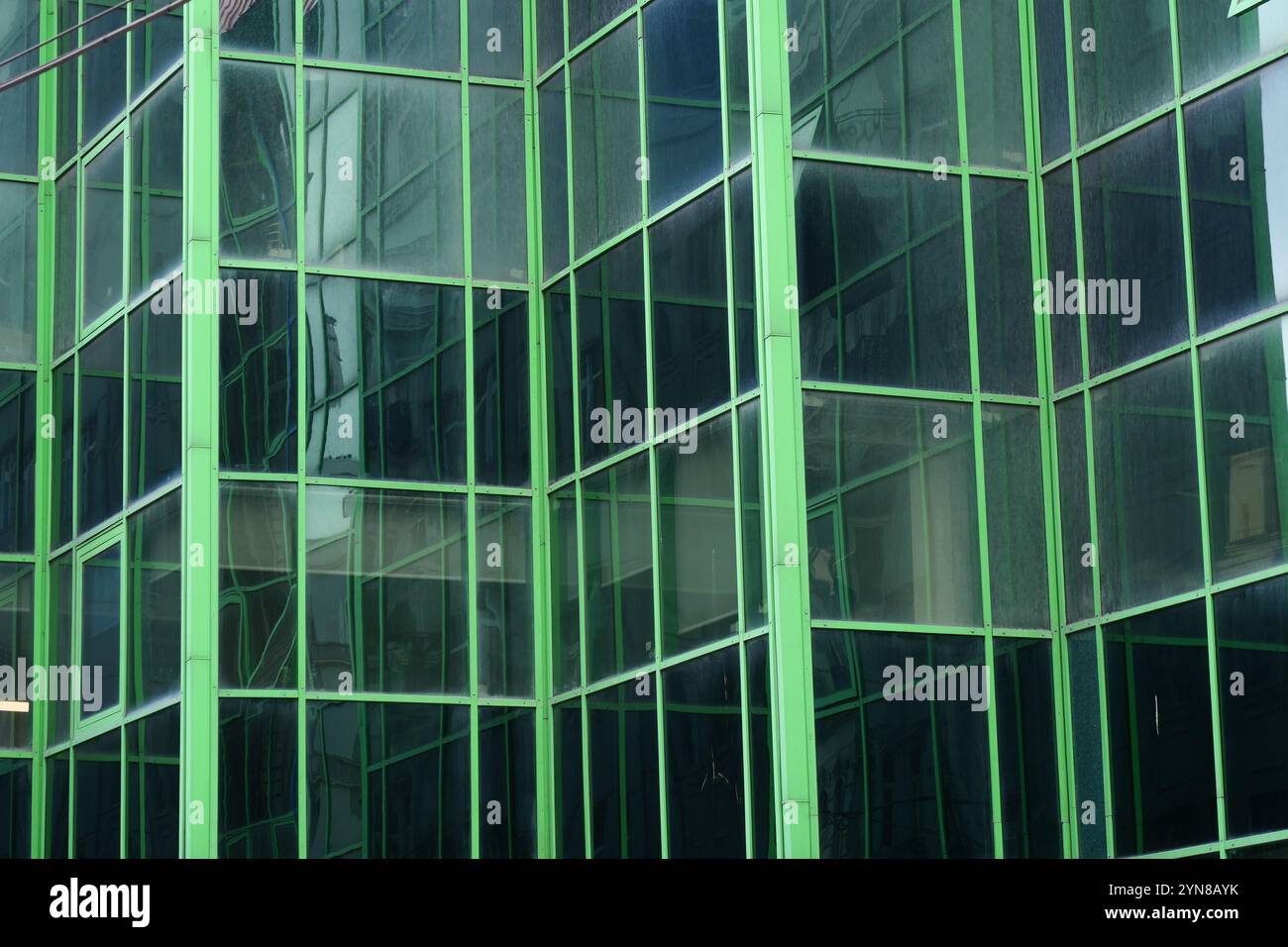 A Modern Green Glass Building Facade Featuring Striking and Intricate ...
