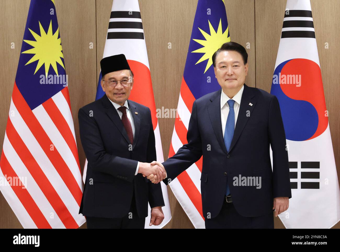 South Korean President Yoon Suk Yeol, right, shakes hands with Malaysia ...