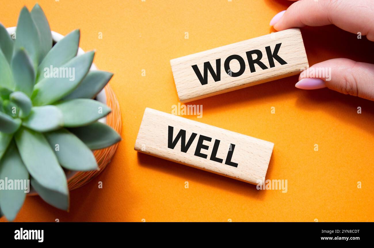 Work Well symbol. Concept word Work Well on wooden blocks. Businessman ...