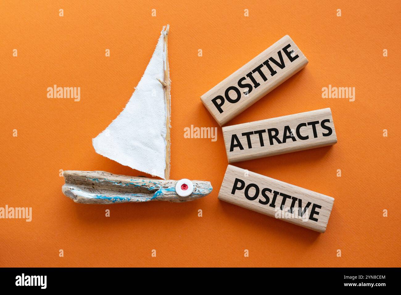 Positive attracts Positive symbol. Wooden blocks with words Positive ...
