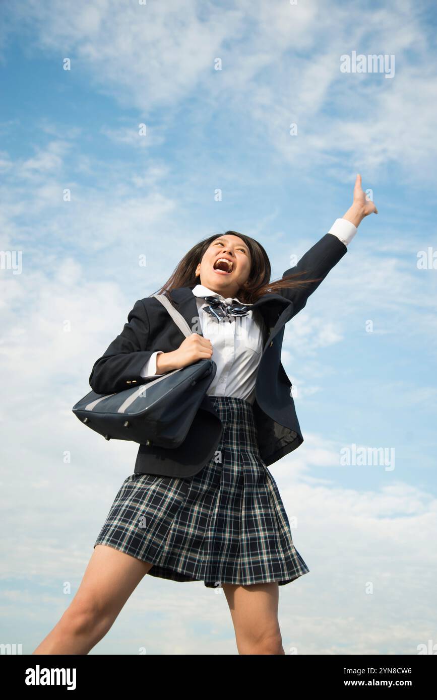 High school girl in school uniform jumping Stock Photo - Alamy