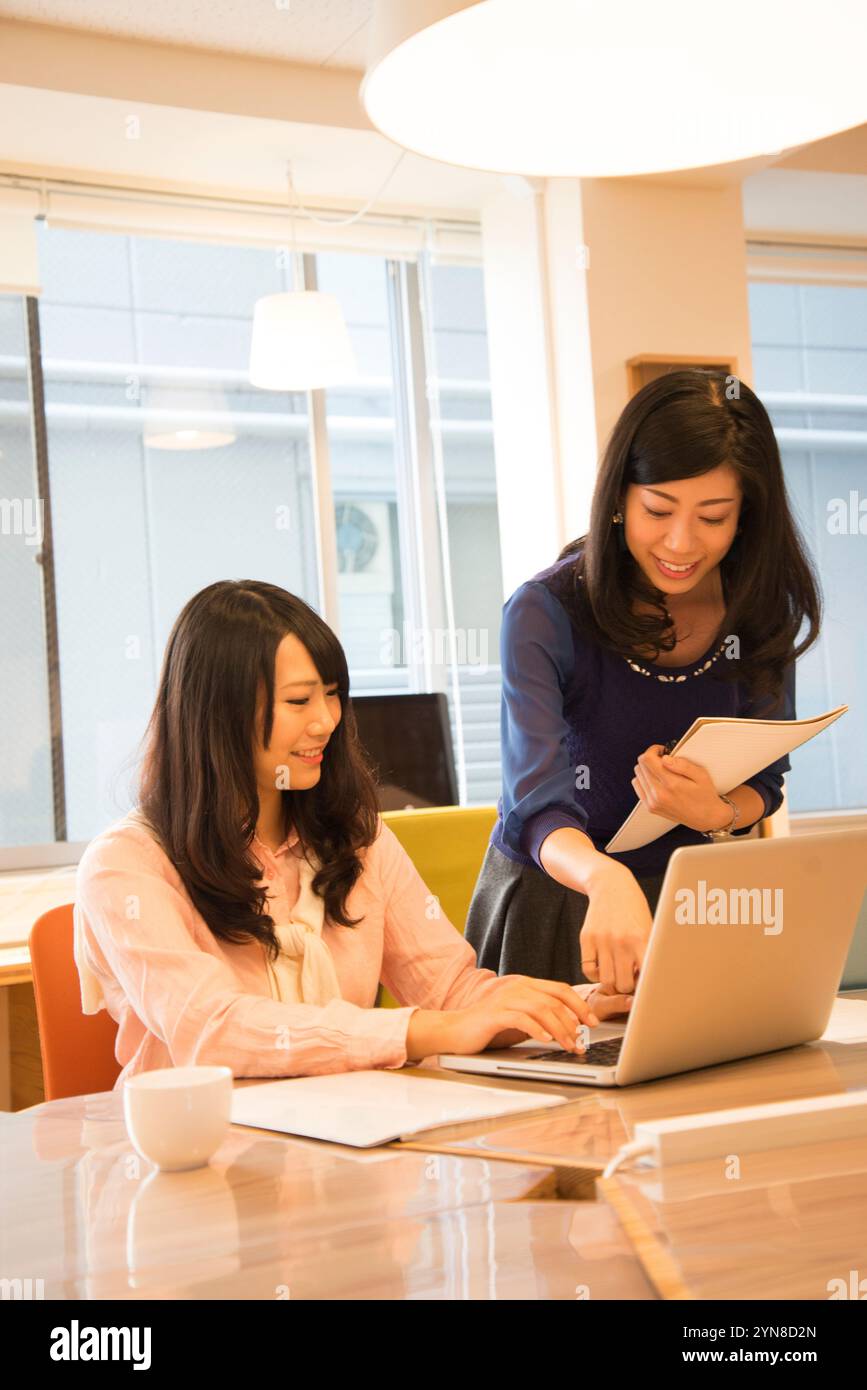 Two women in office Stock Photo - Alamy