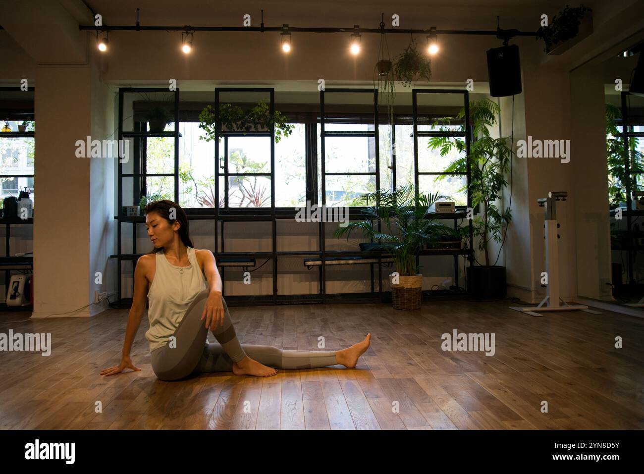 Female yoga instructor doing a pose on the floor Stock Photo - Alamy