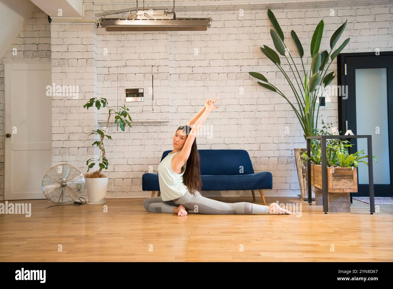 Female yoga instructor doing a pose on the floor Stock Photo - Alamy