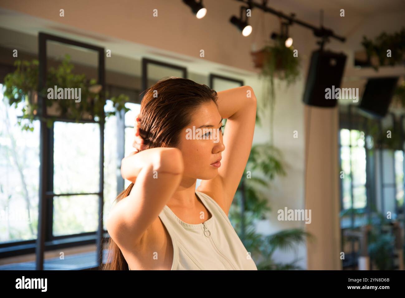Female yoga instructor doing a pose in studio Stock Photo - Alamy