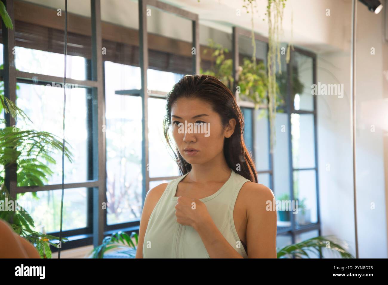 Female yoga instructor looking in mirror Stock Photo - Alamy