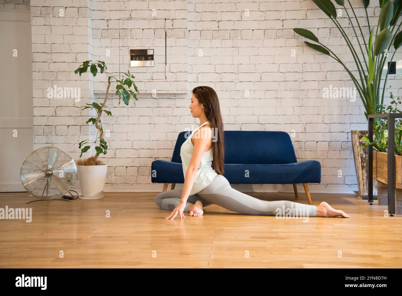 Female yoga instructor doing a pose on the floor Stock Photo - Alamy