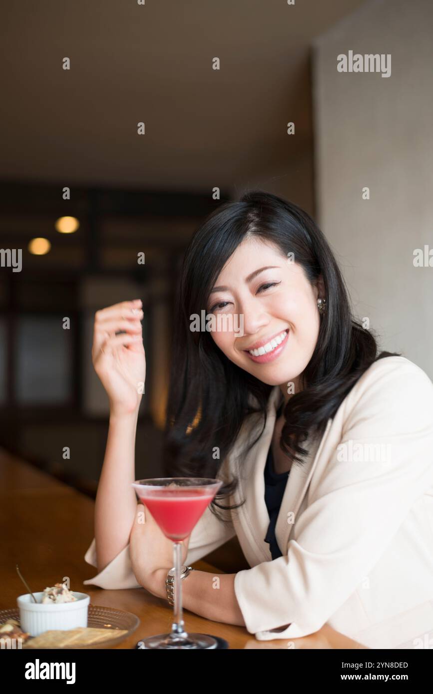 Woman laughing alone at a bar Stock Photo - Alamy