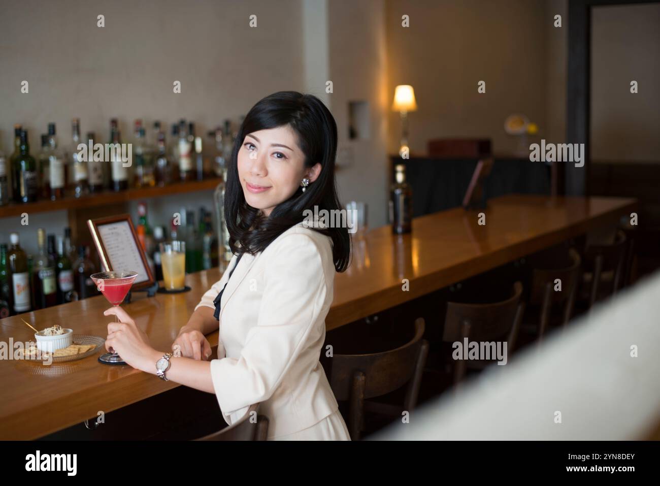 Woman alone at a bar hi-res stock photography and images - Alamy
