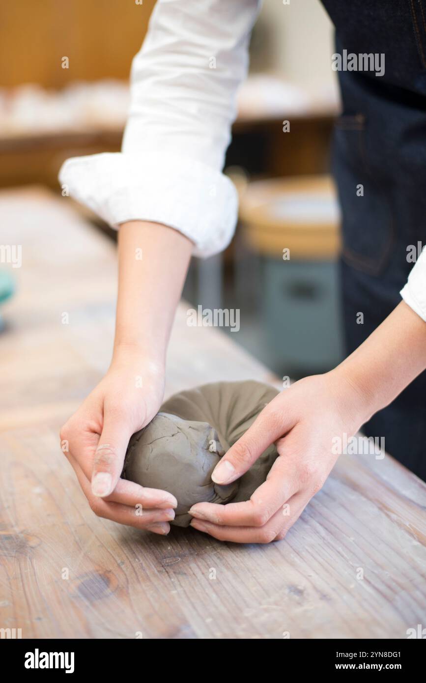 Woman's hands kneading clay in the pottery class Stock Photo - Alamy