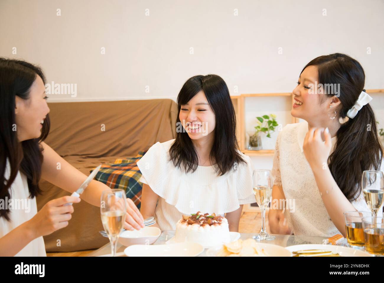 Smiling woman eating birthday cake hi-res stock photography and images ...