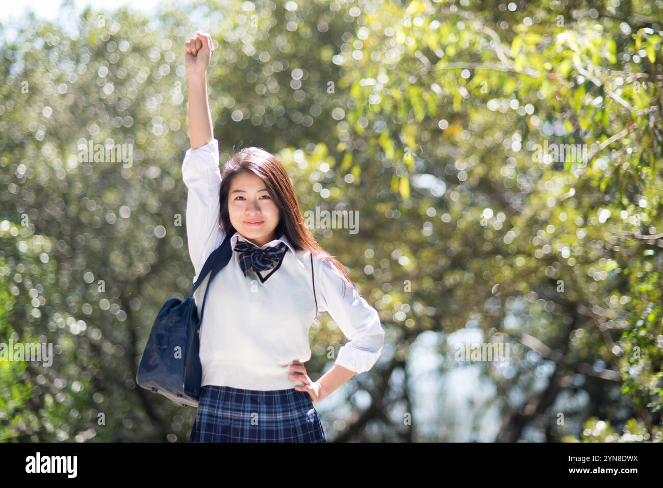 High school girl in uniform with one hand raised Stock Photo - Alamy