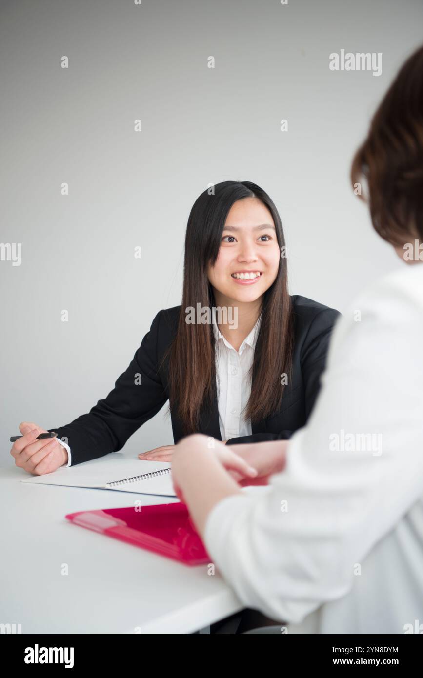 Two women talking in conference room Stock Photo - Alamy