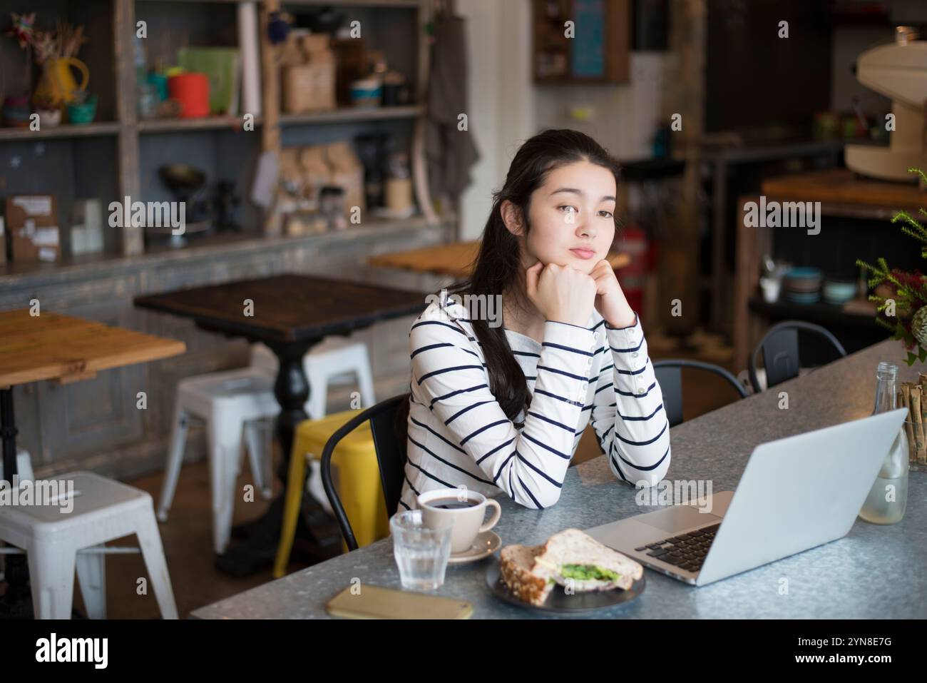Woman opening a computer in a café Stock Photo - Alamy
