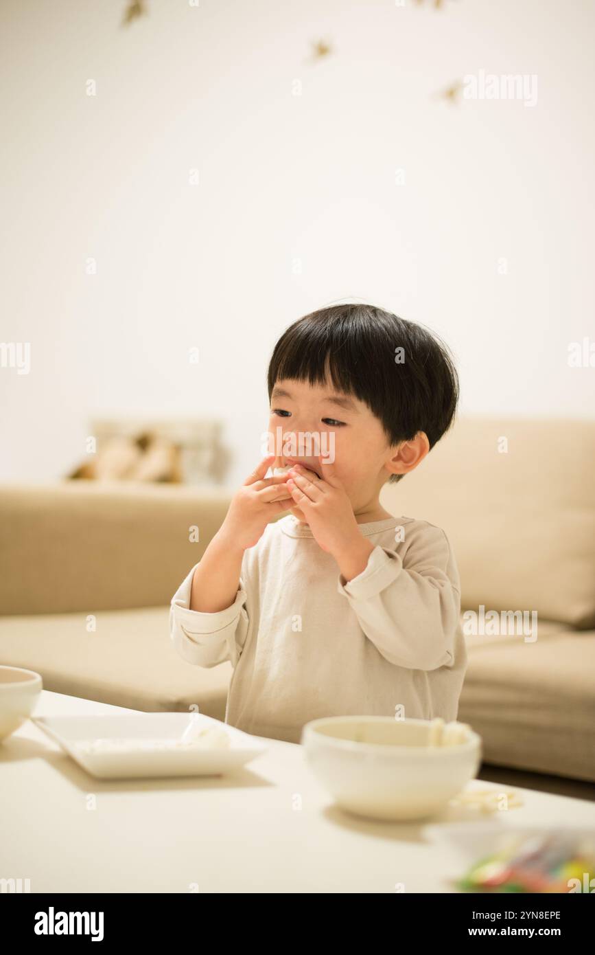 Boy eating rice Stock Photo - Alamy