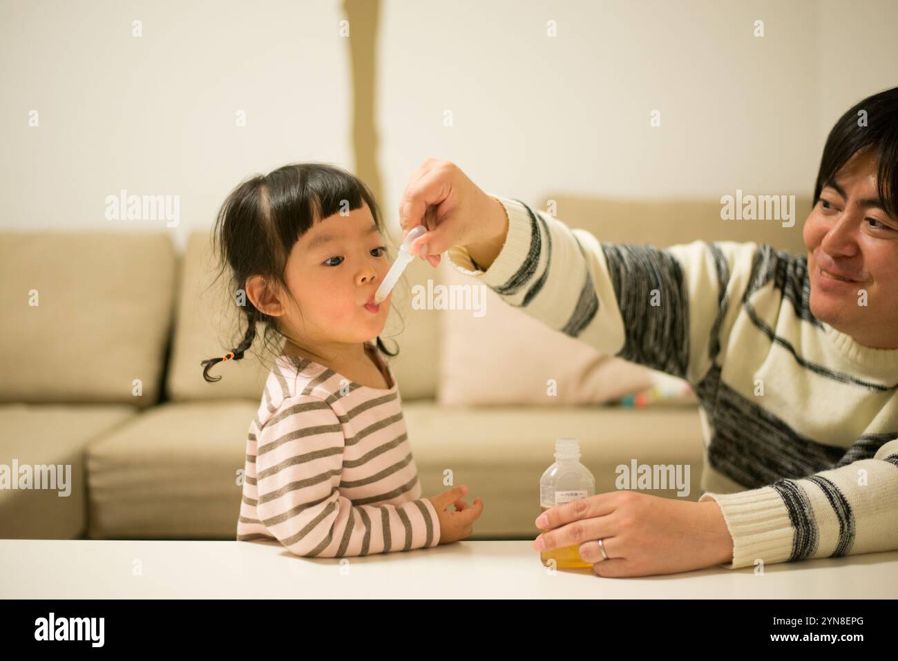 Child taking medicine hi-res stock photography and images - Alamy