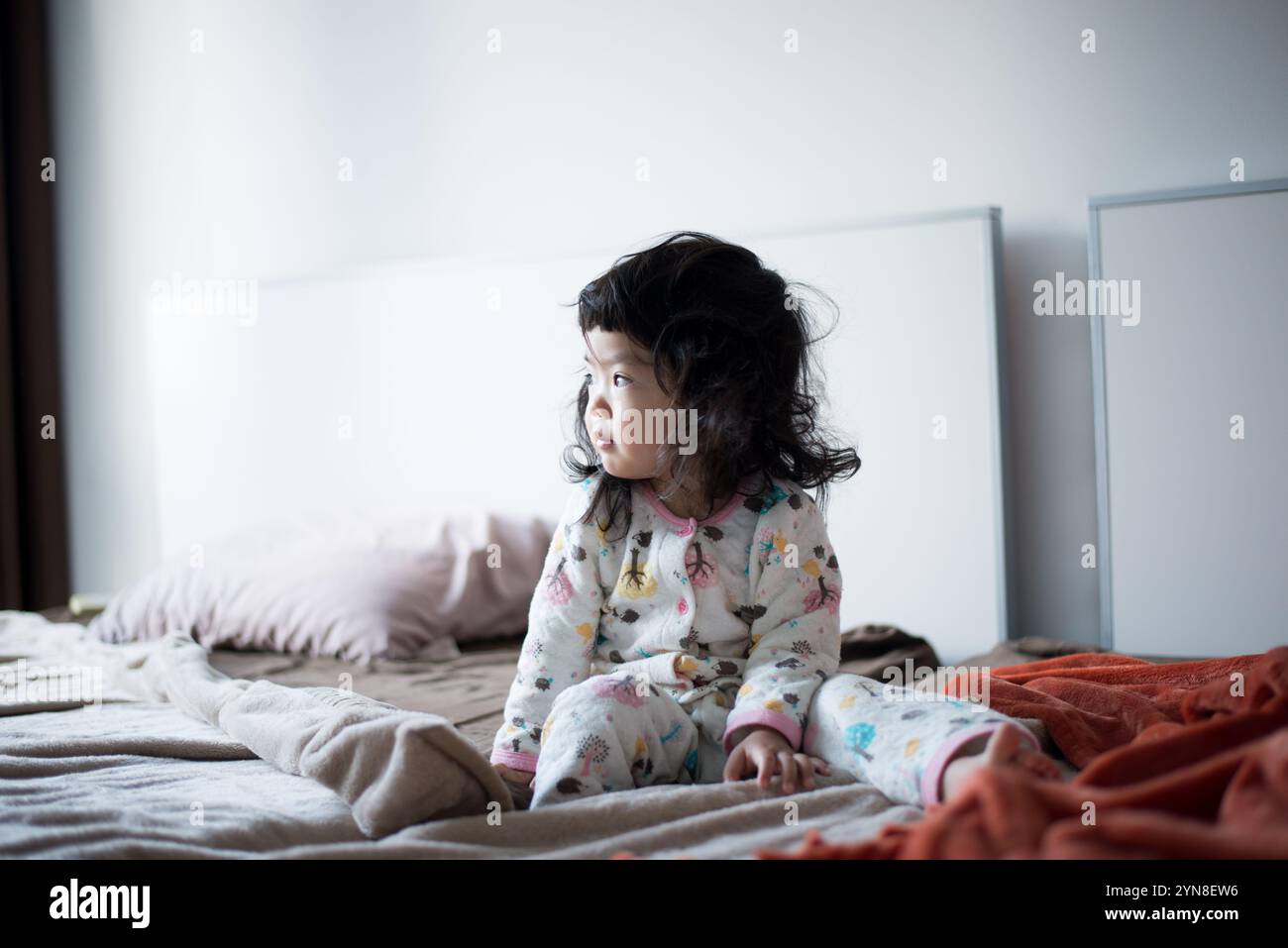 Girl waking up in bed Stock Photo - Alamy