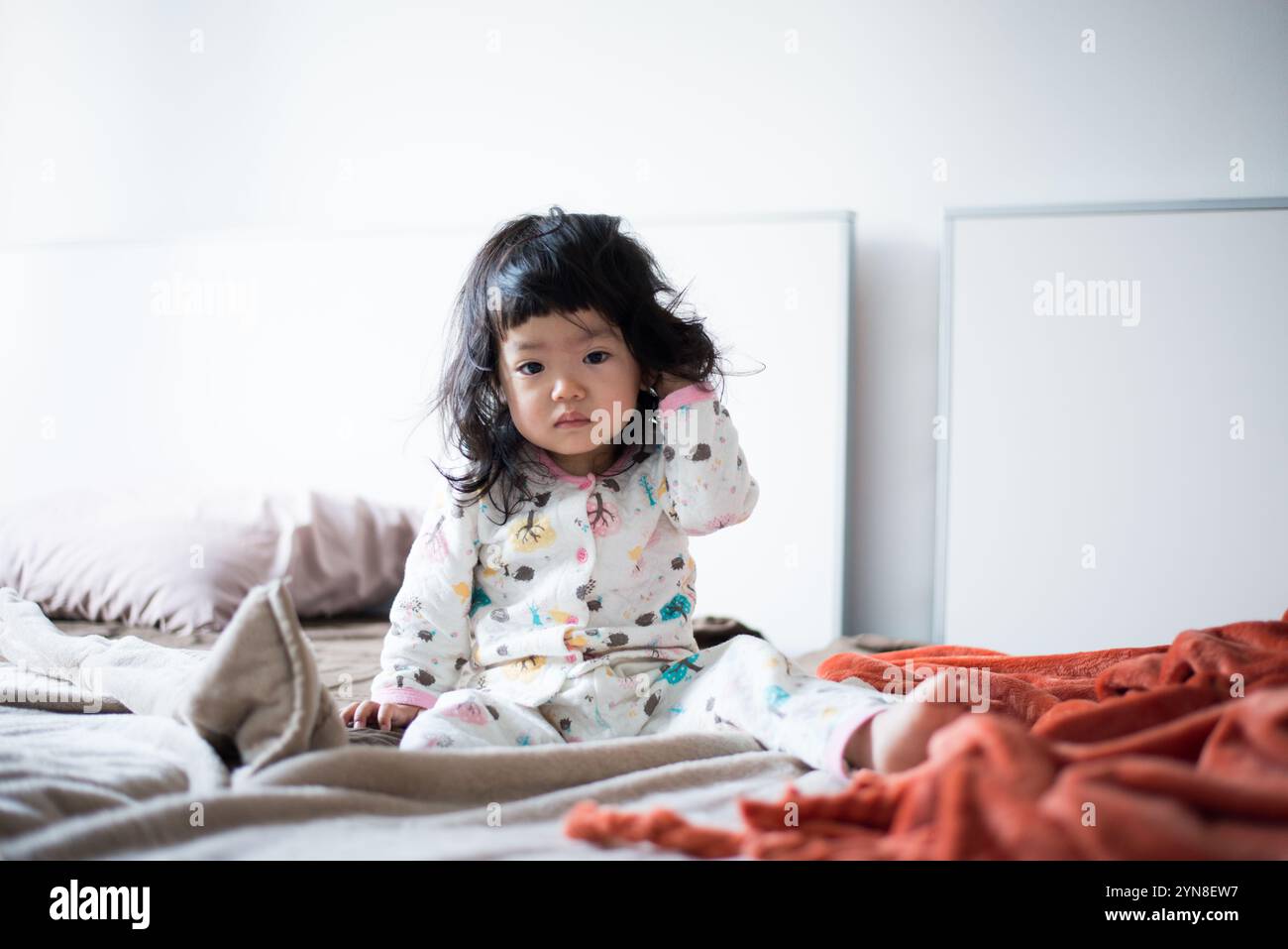 Girl waking up in bed Stock Photo - Alamy