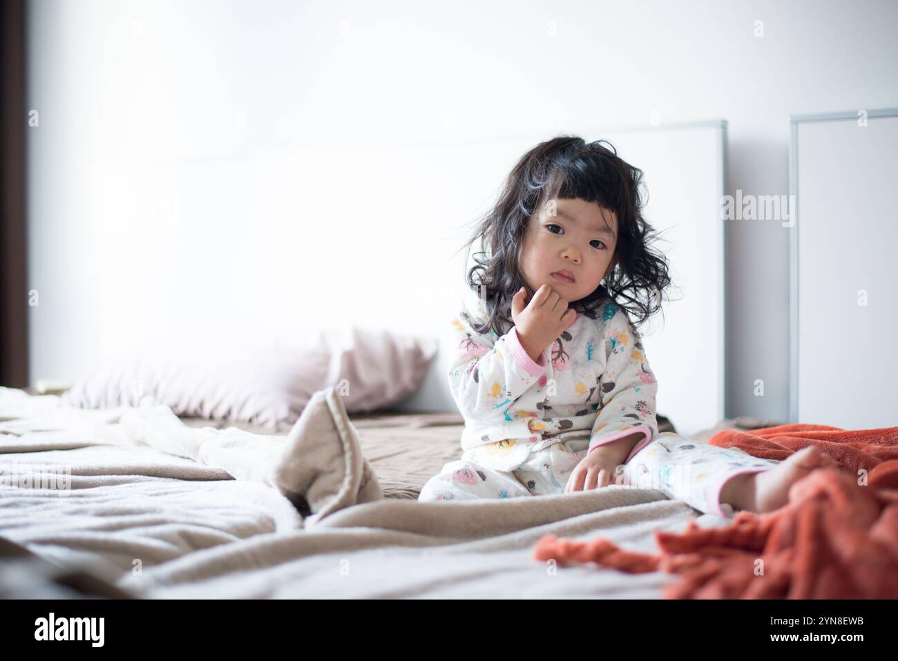 Girl waking up in bed Stock Photo - Alamy