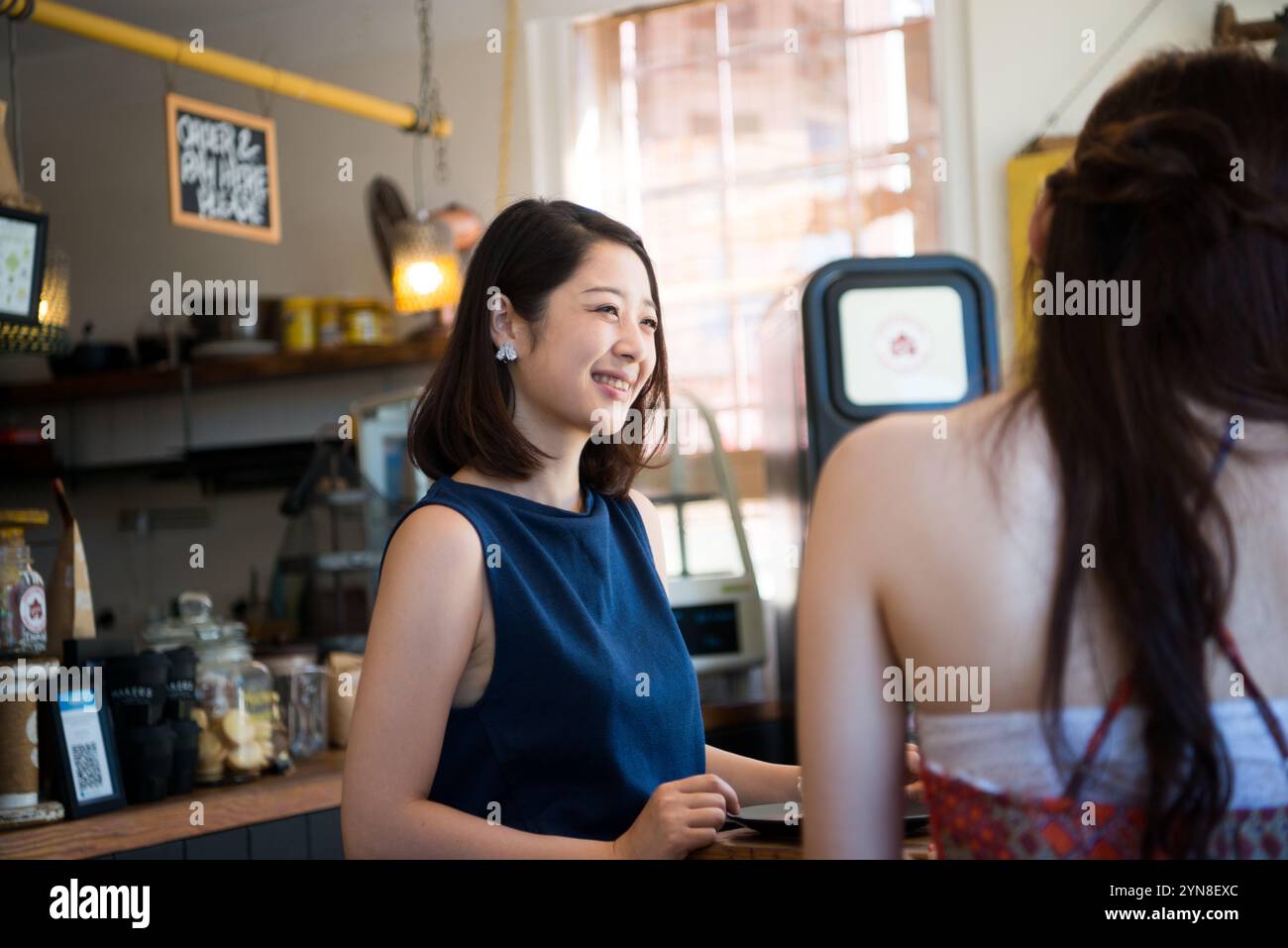 Two people chatting at a café Stock Photo - Alamy