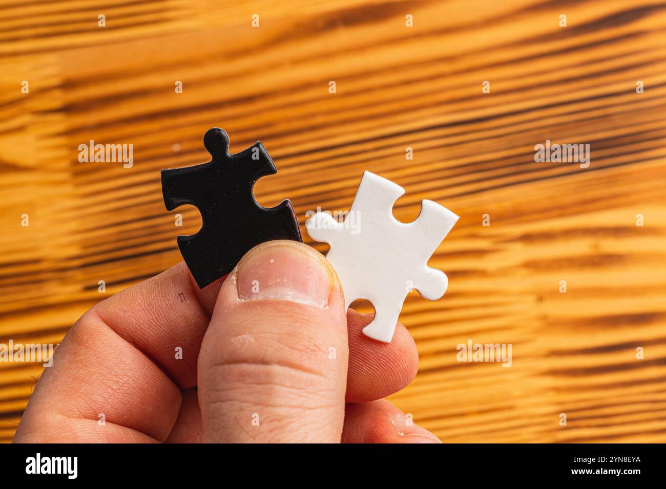 Hands holding black and white puzzle, concept of difficult option ...