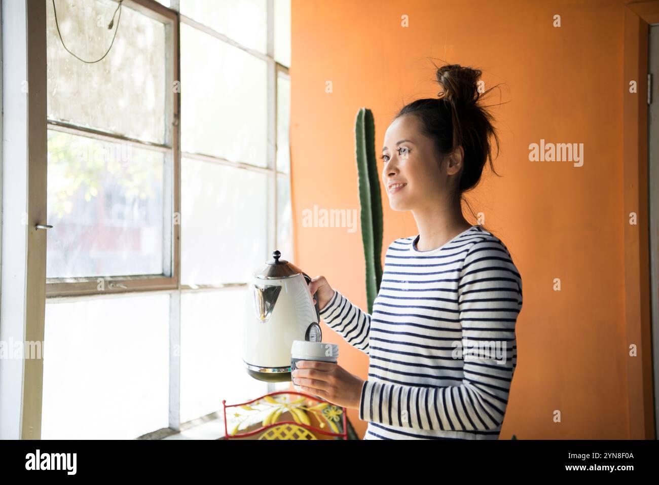 Woman laughing with pot Stock Photo - Alamy