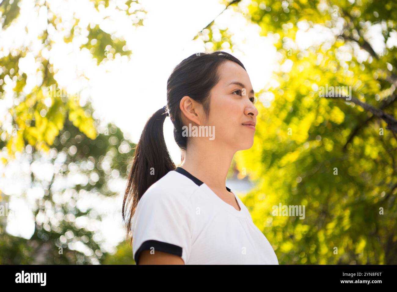 Woman looking sideways Stock Photo - Alamy