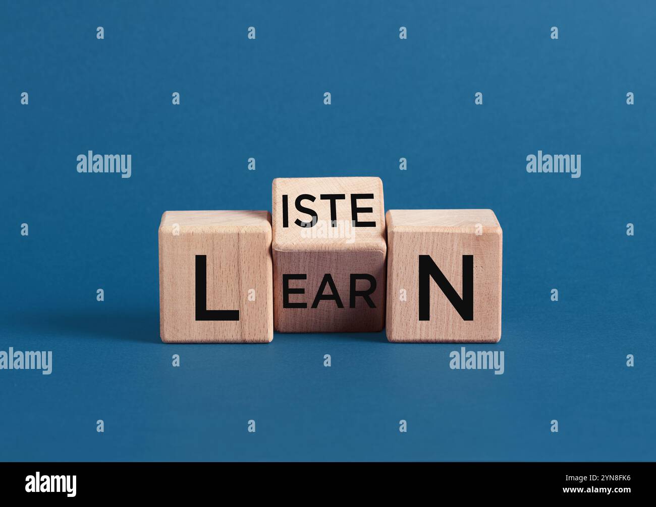 Wooden cubes spelling listen and learn, conveying the importance of ...