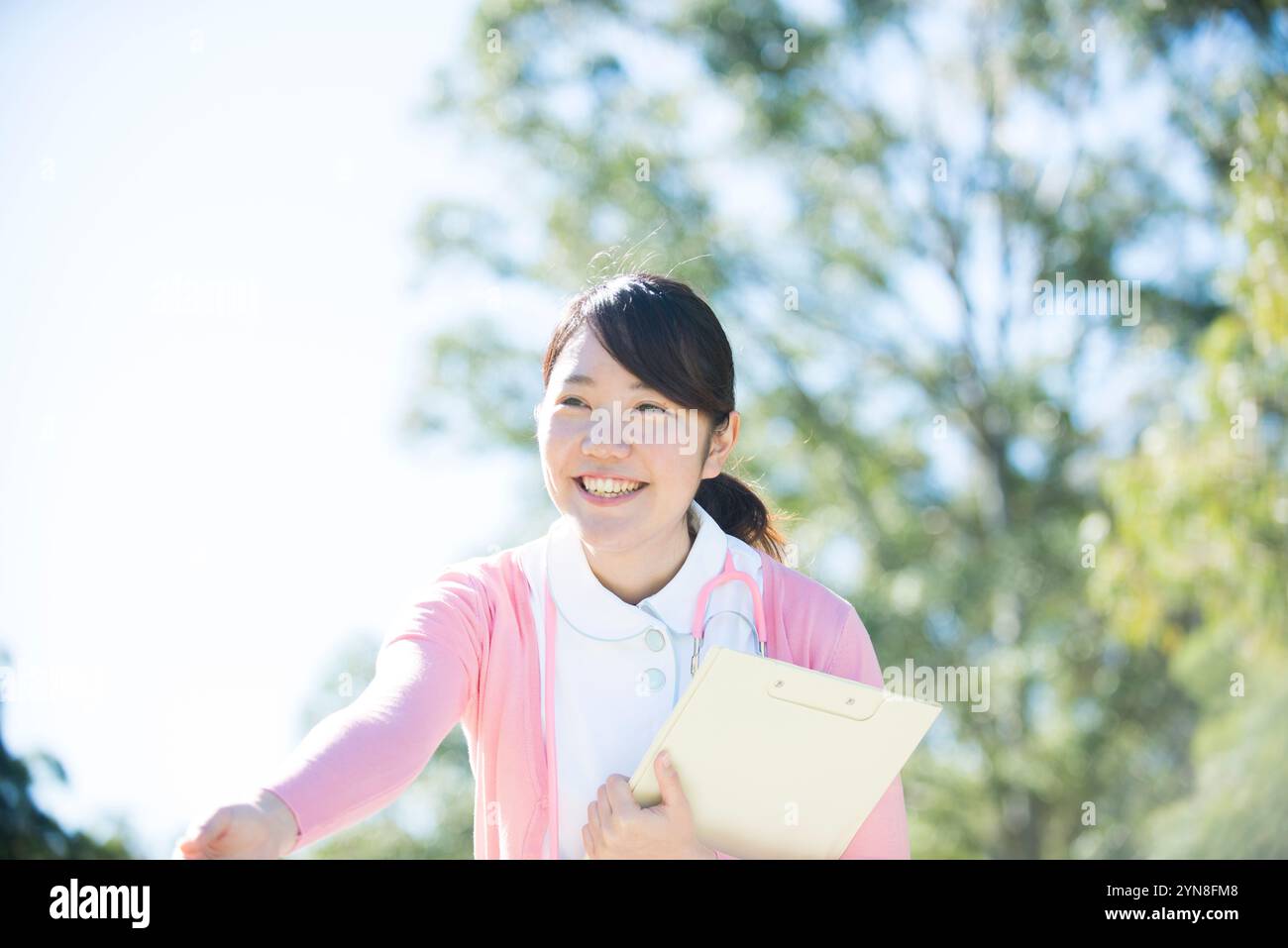 Nurse holding out her hand with a smile Stock Photo - Alamy