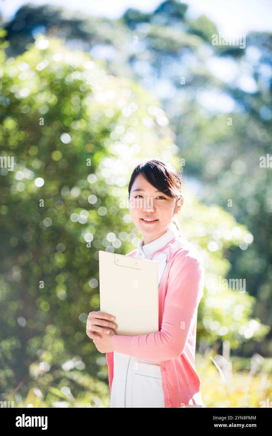 Nurse holding board Stock Photo - Alamy