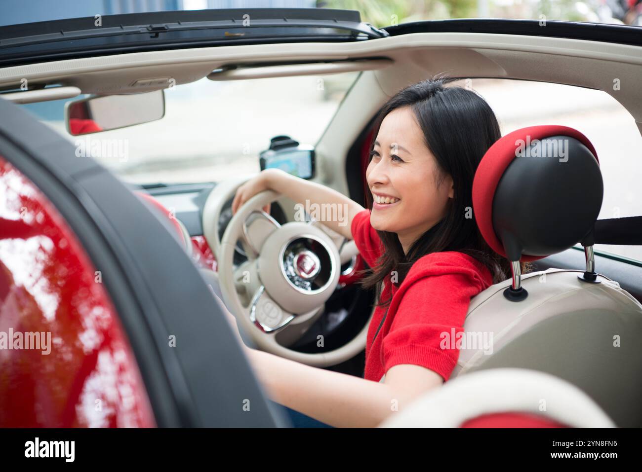 Woman smiling in car Stock Photo - Alamy